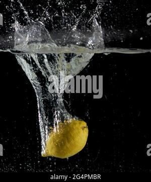 lime and lemon splashing water isolated on white background Stock Photo - Alamy