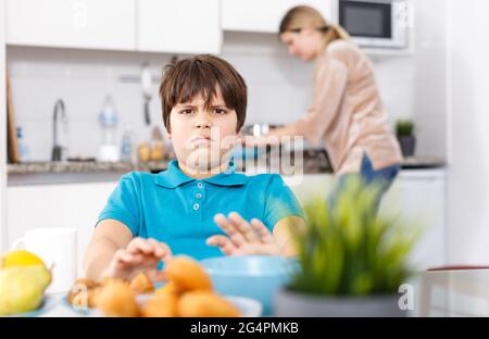Displeased boy refusing to eat Stock Photo - Alamy