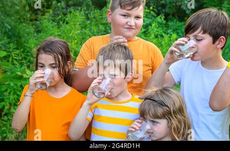 Children drink water outside together. Selective focus. Kids Stock ...