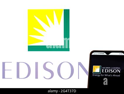 In this photo illustration, the Edison International logo is displayed ...
