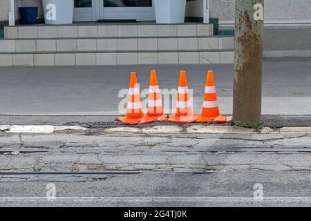 Orange Traffic Cones Chained to Pole at Street Stock Photo - Alamy