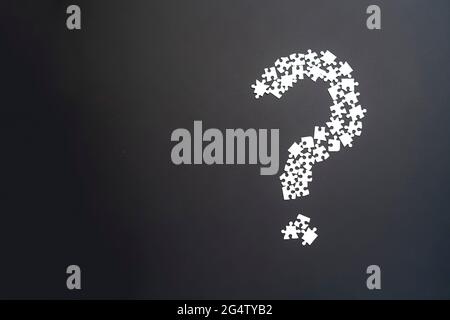 closeup puzze question mark on dark background isolated Stock Photo - Alamy