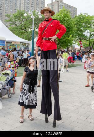 Canadian mountie on a Canada Day holiday on stilts poses with a smiling ...