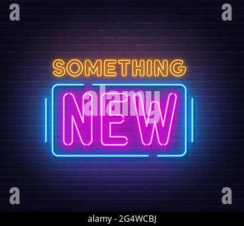 Something new neon sign on brick wall background. Yellow and pink neon ...