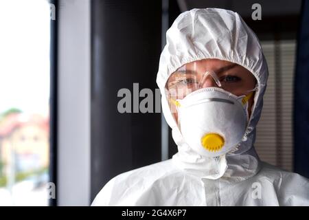 Female office worker in protective medical mask is having productive ...