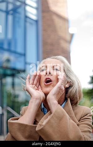 Senior woman shouting Stock Photo - Alamy