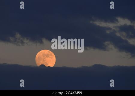 The first full moon of the year known as a Wolf Moon is seen behind the ...