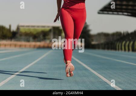 Athlete running in a stadium Stock Photo - Alamy