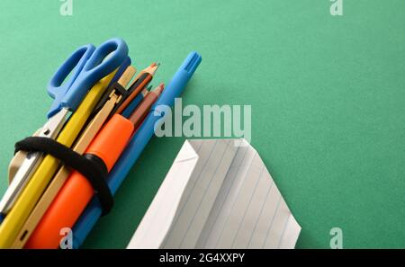 Paper plane on green background Stock Photo - Alamy