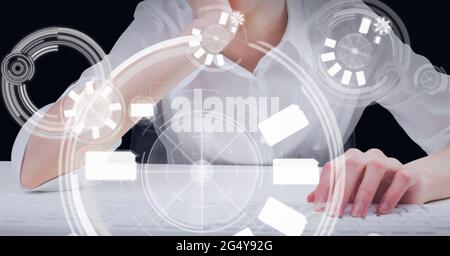 Multiple round scanners against mid section of woman using computer ...