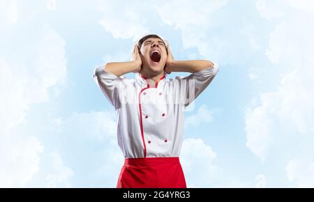 Young male chef screaming in shock and horror Stock Photo - Alamy