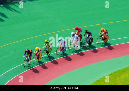 Female competitors in a "keirin" cycle race at Kyoto Keirin Racetrack ...