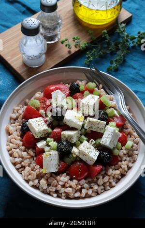 Round blue cheese with salad and basil Stock Photo - Alamy