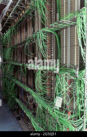 Vertical shot of a server room with green wires Stock Photo - Alamy