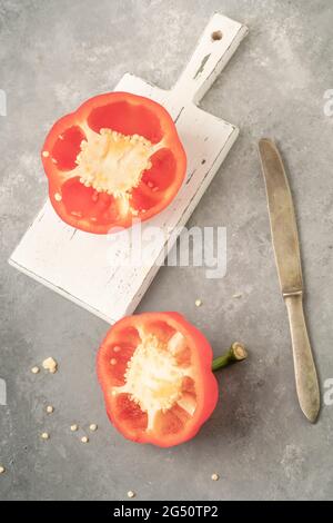 one fresh halved red bell pepper on gray background with copy space ...