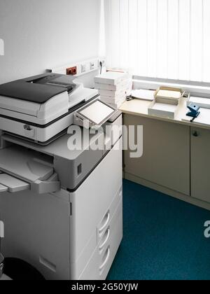 Interior of light office with workplace, printer and shelf units Stock ...