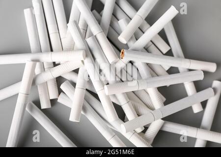 Many cigarettes on light background Stock Photo - Alamy