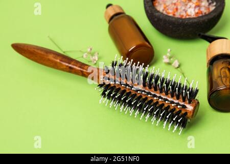 Hair brush, sea salt and cosmetics on color background Stock Photo - Alamy