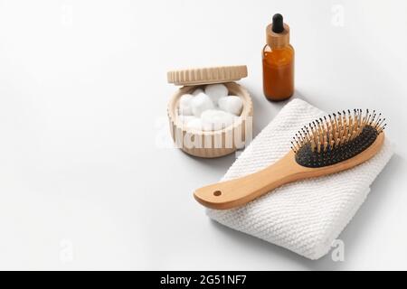 Hair brush, towel and cotton balls on color background Stock Photo - Alamy
