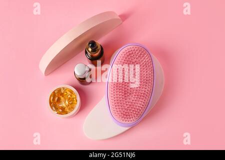 Hair brush, fish oil pills and lavender on color background Stock Photo ...