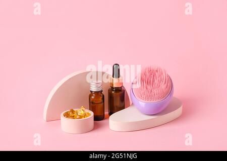 Hair brush and fish oil pills on light wooden background Stock Photo ...