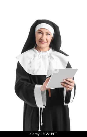 Mature nun with tablet computer on white background Stock Photo - Alamy
