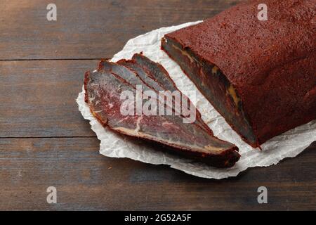 Sliced basturma meat on brow wooden background Stock Photo - Alamy
