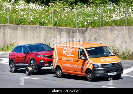 RAC VW van towing Peugeot car for breakdown recovery service or car ...