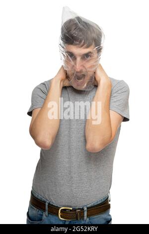 Mature man with a transparent plastic bag flying over his head and face ...