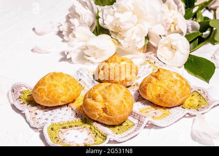 Profiteroles with blueberries. Custard cakes, Eclair, cream puff ...