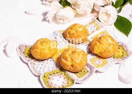 Profiteroles with blueberries. Custard cakes, Eclair, cream puff ...