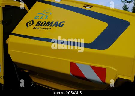 Huge yellow Bomag heavy road machine close-up parked and ready for road ...