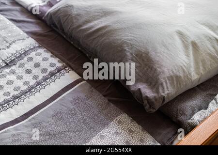 bed maid up with a simple abstract pillow design on top Stock Photo - Alamy