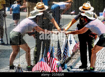 Pointing fingers find a name on the Vietnam War Memorial in Washington ...