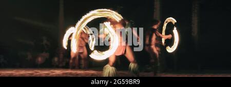 Fire dancers at Hawaii luau show, polynesian hula dance men jugging ...
