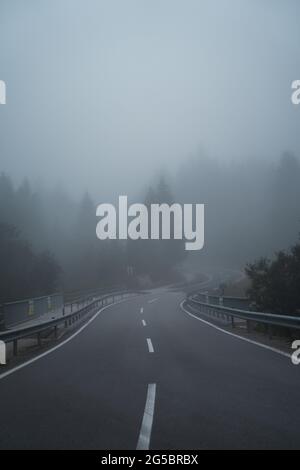 Smooth highway through a scenic autumn wood Stock Photo - Alamy