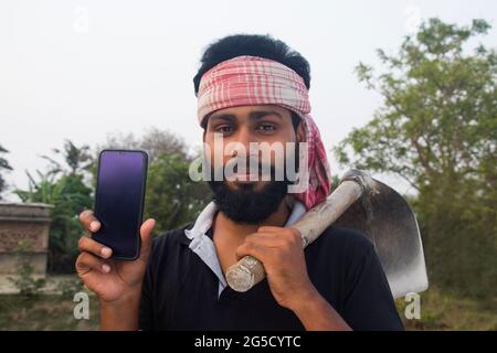 Young indian farmer showing Smart phone , Farmer talking on phone in ...