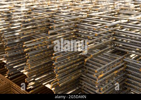Stack of welded wire reinforcement steel mesh sheets and bags with ...