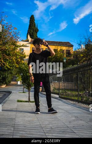 Young exotic boy model posing on the street Stock Photo - Alamy