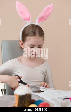 Easter creativity. Cut out paper rabbit, back view. Carved tropical ...