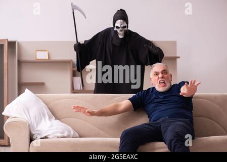 Devil coming to old dying man Stock Photo - Alamy