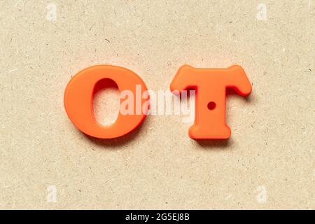 Alphabet letter in word OT (abbreviation for overtime) on wood ...