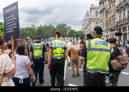 Protesters dressed in fake police uniforms with the word ‘Peace ...