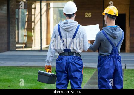 two builders discussing the interior of a half completed house Stock ...