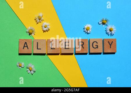 Allergies, word in wooden alphabet letters isolated on green and blue ...