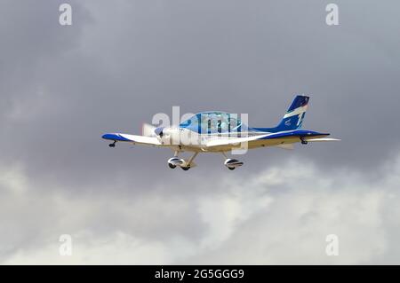 A light sport airplane performing aerobatic maneuver stunts in a cloudy ...