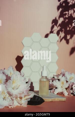 Essential oil on the trendy geometric background Stock Photo - Alamy