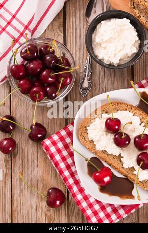 Rye bread with cottage cheese and cherries Stock Photo - Alamy