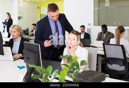 Upset girl with dissatisfied businessman in coworking space Stock Photo ...