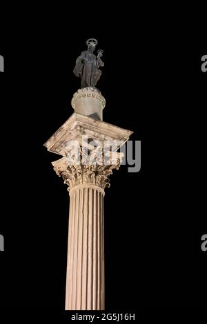 Italy, Rome, Column of Peace (Colonna della Pace) at night with statue ...